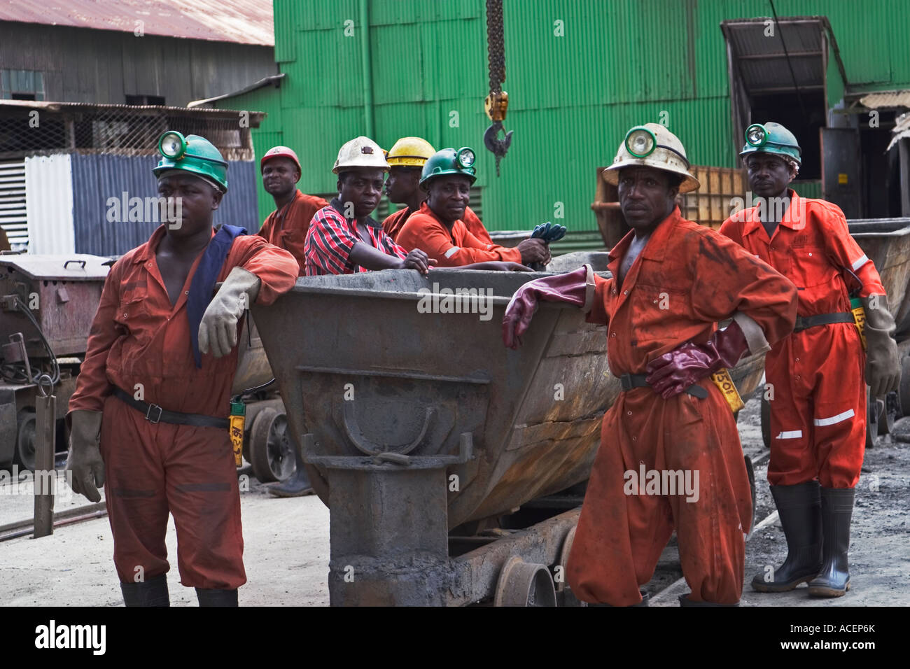 Gold miners with mining ore truck at pit head waiting to go underground ...