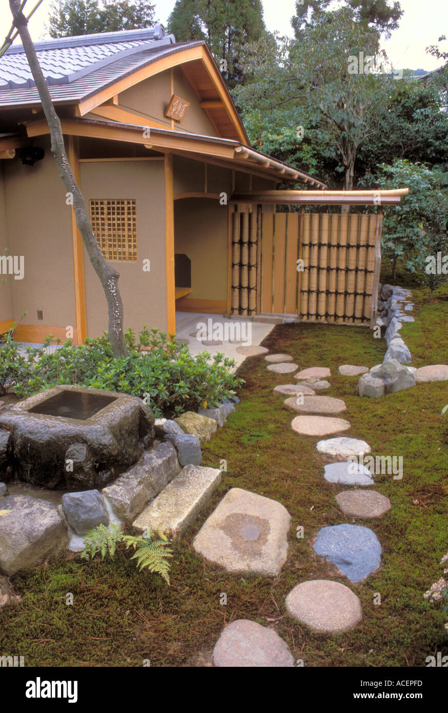 Stepping stone garden pathway leading to a traditional Japanese ...