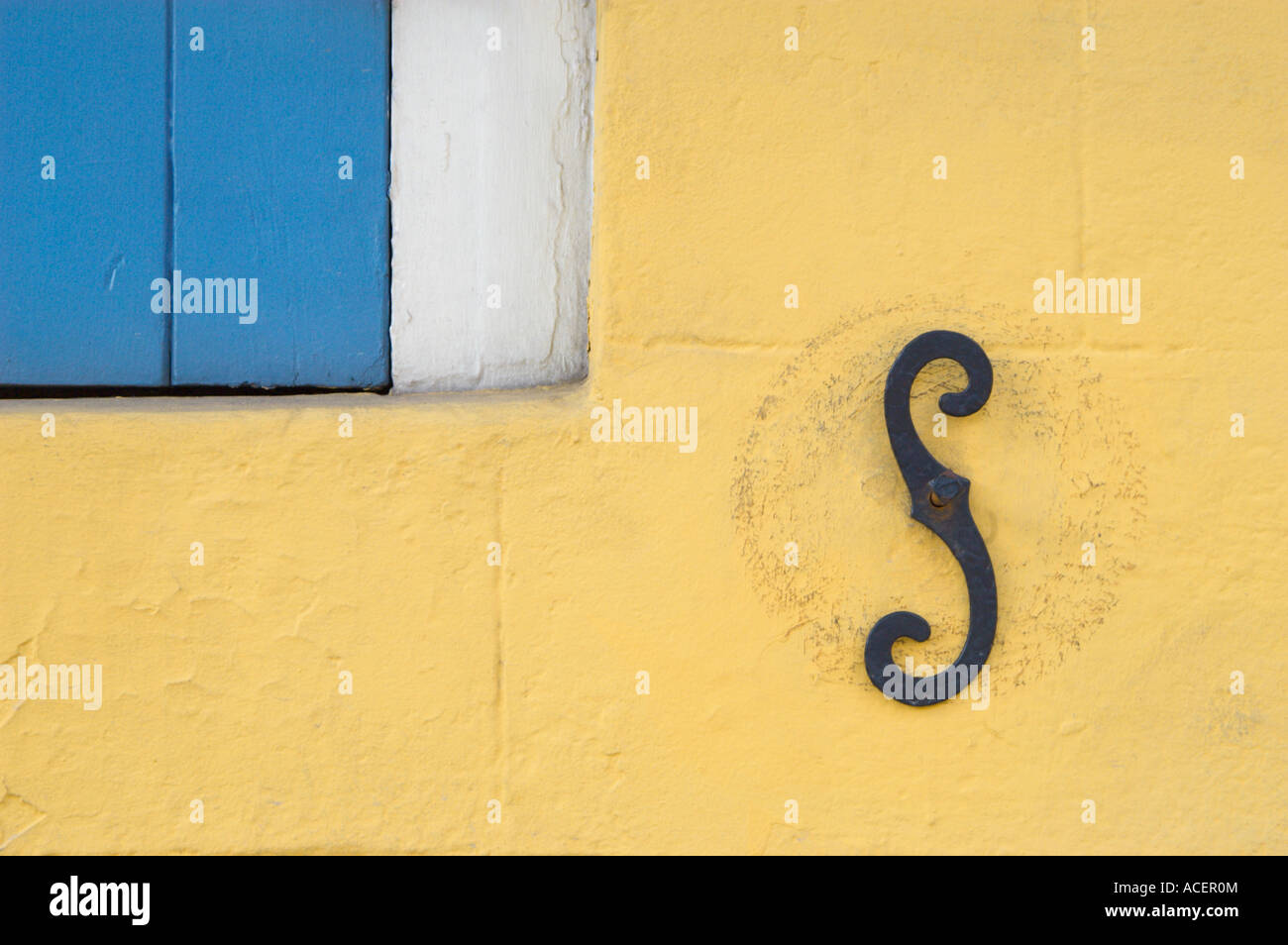 Colorful window shutter and S-shaped shutter dog in the French Quarter ...