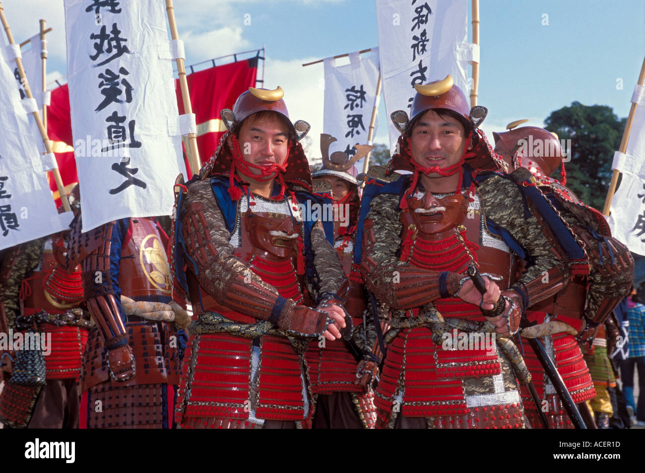 Two men dressed in samurai warrior costumes get ready to draw their ...