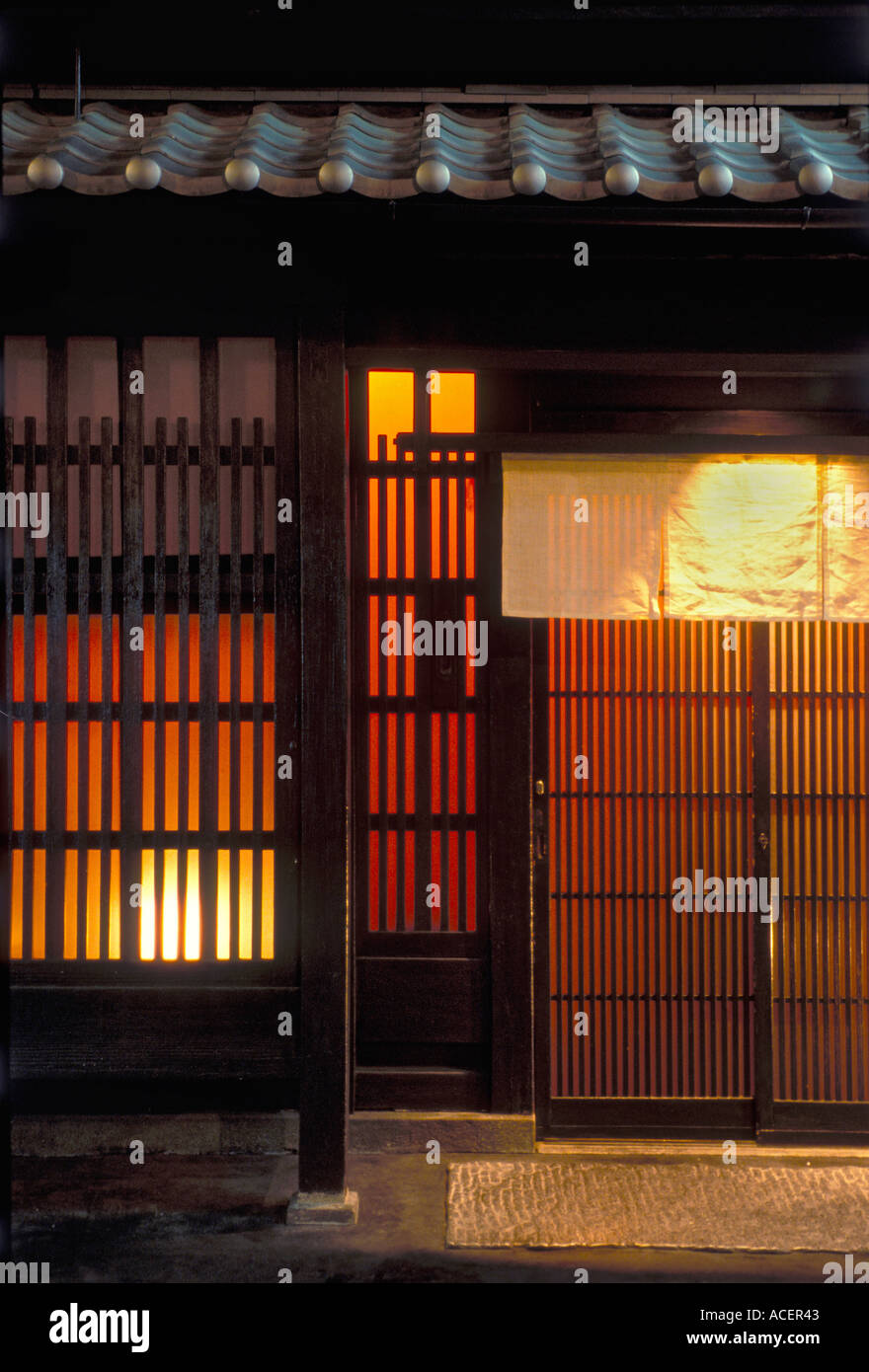 Warm glow coming from inside a machiya townhouse in historic Gion ...