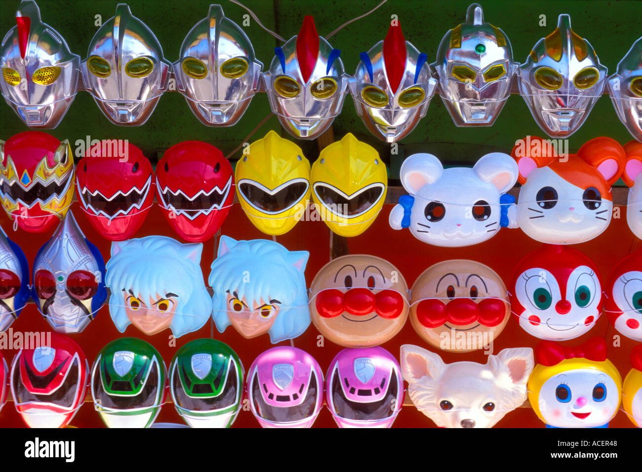 Collection of colorful plastic super hero and animation character masks ...