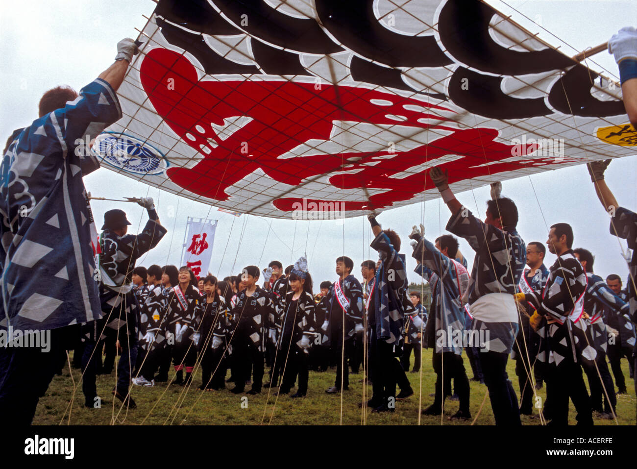 Team wearing costumes prepare their kite for flight and battle at ...