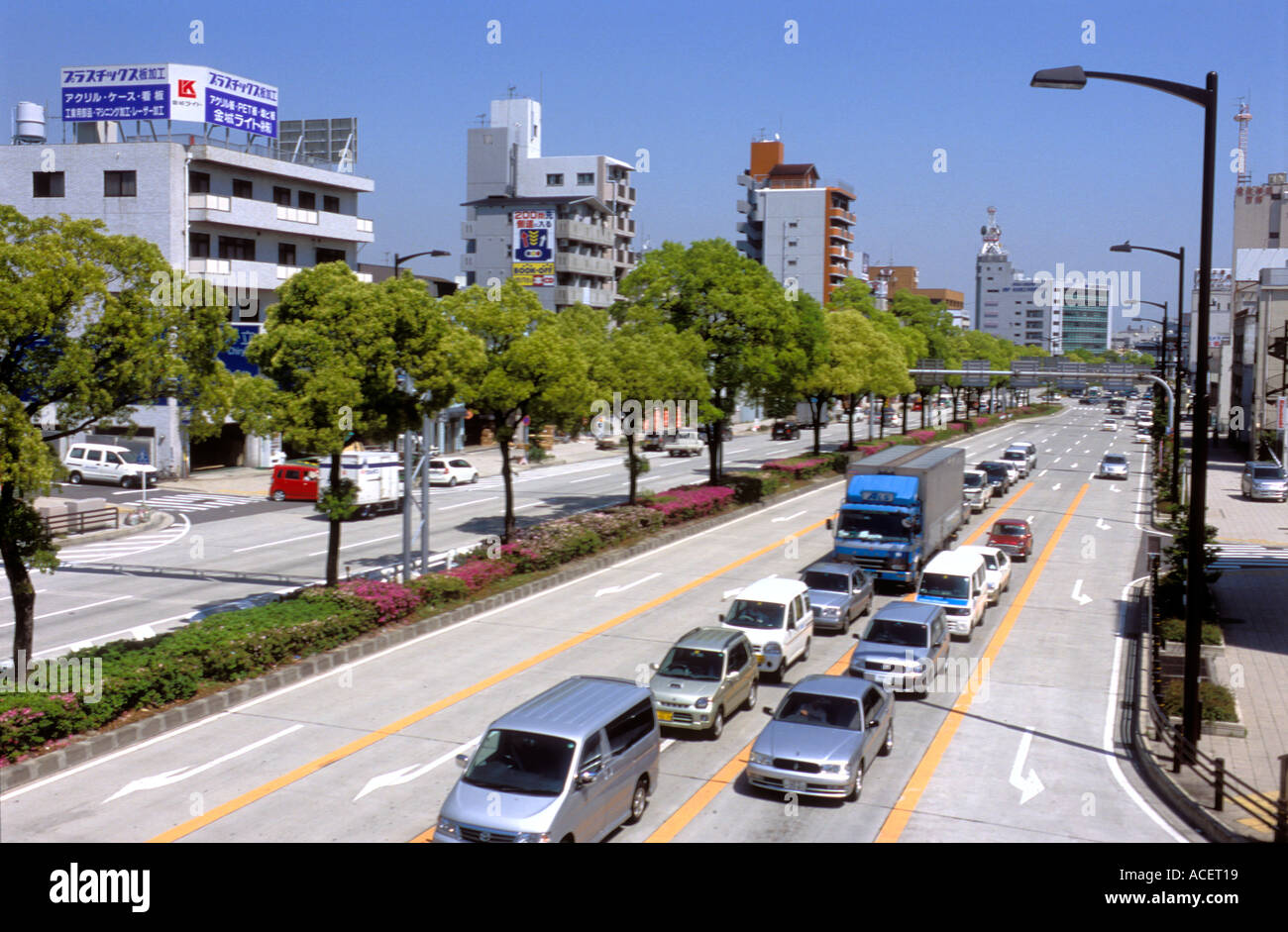 Wide boulevard separated by island of trees is common in Nagoya city ...