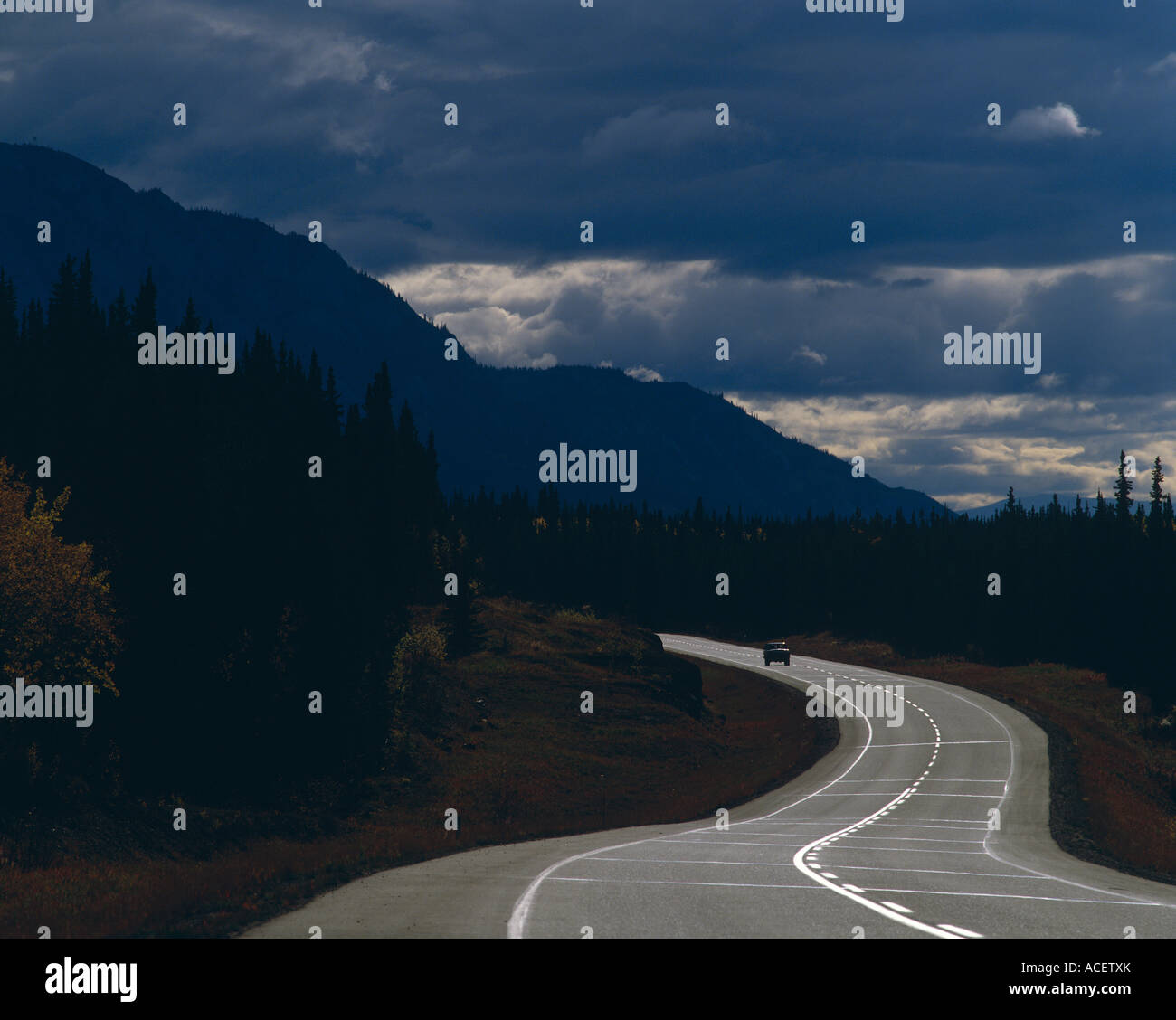 Car driving on highway between mountains Stock Photo - Alamy