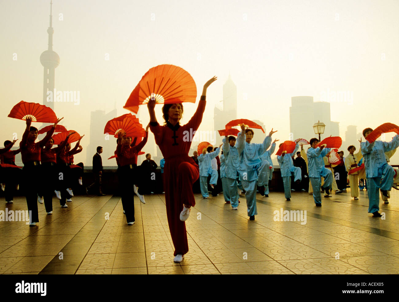 Shanghai China Women morning exercise team doing routine with fans on ...
