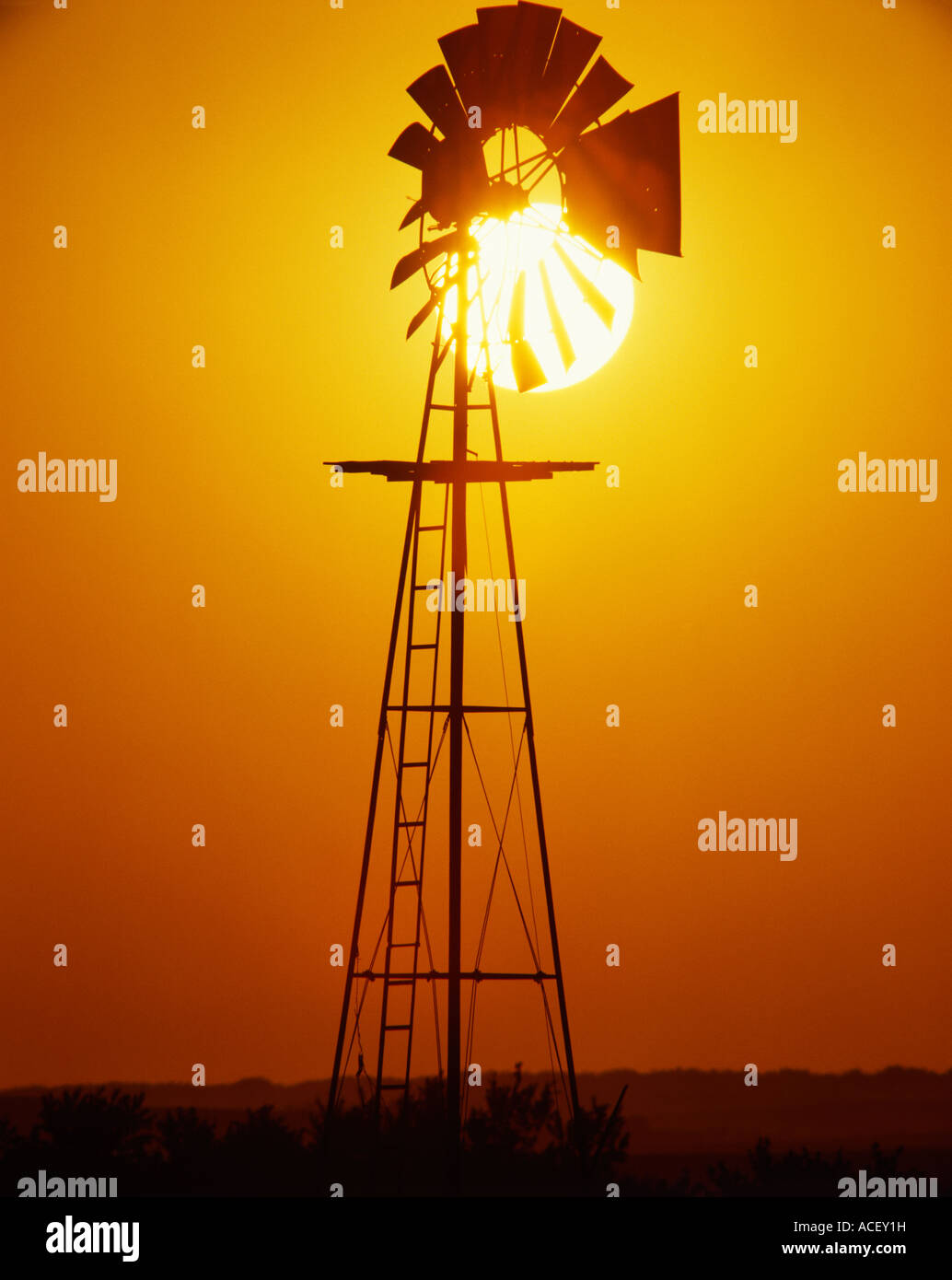 Wind mill large sun behind Stock Photo - Alamy