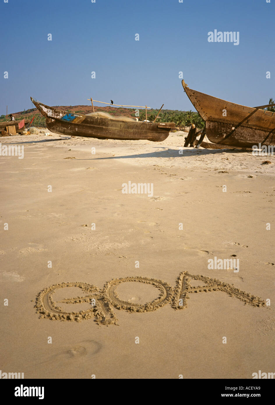 India word Goa written in sand by fishing boats Stock Photo - Alamy