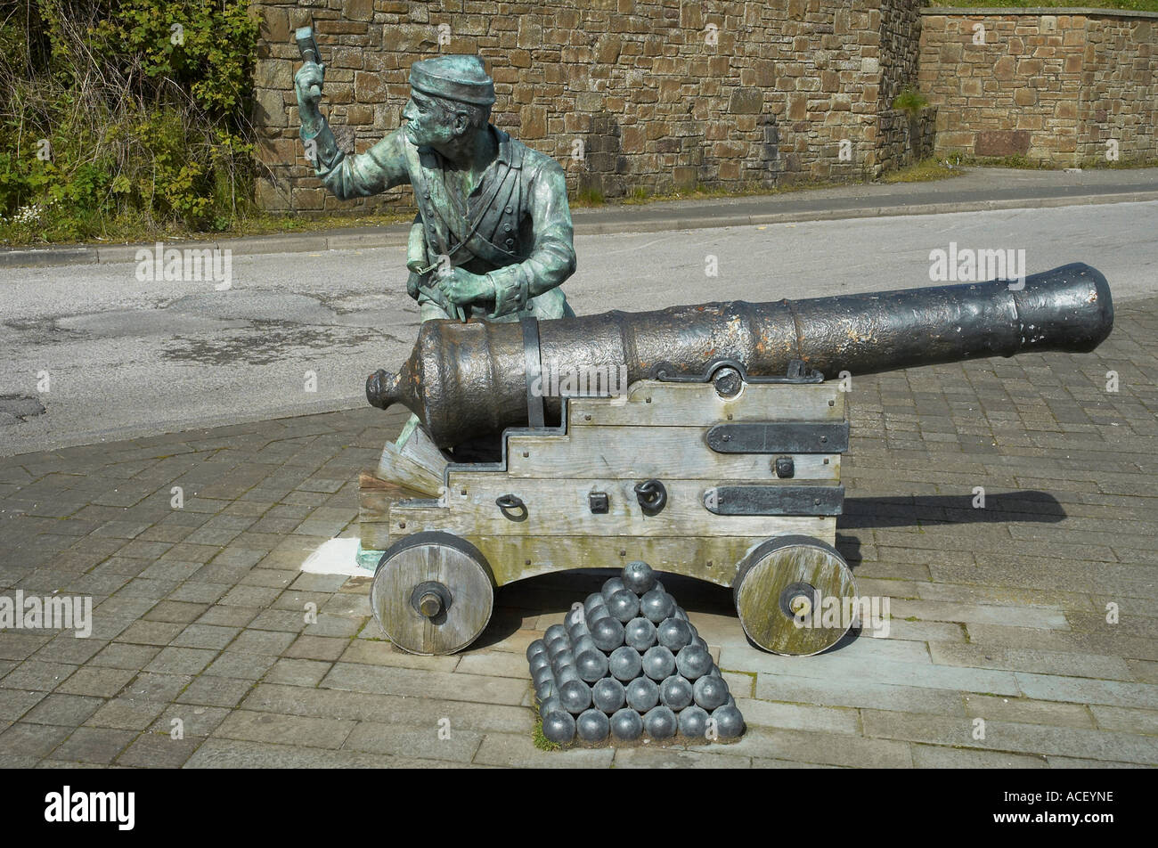 A statue of a male striking a metal spike with a hammer in order to ...
