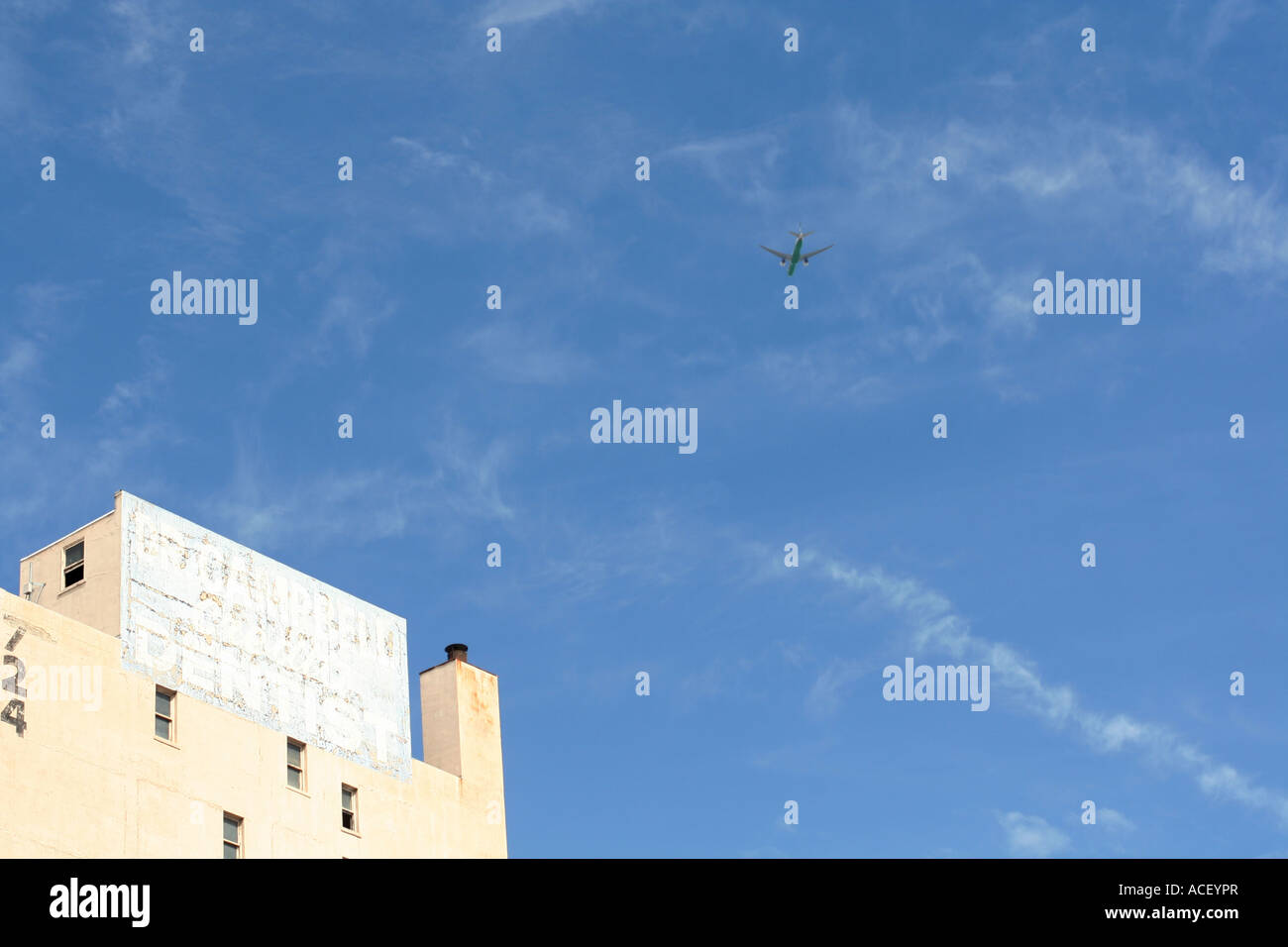 white building blue sky jet airplane Stock Photo - Alamy