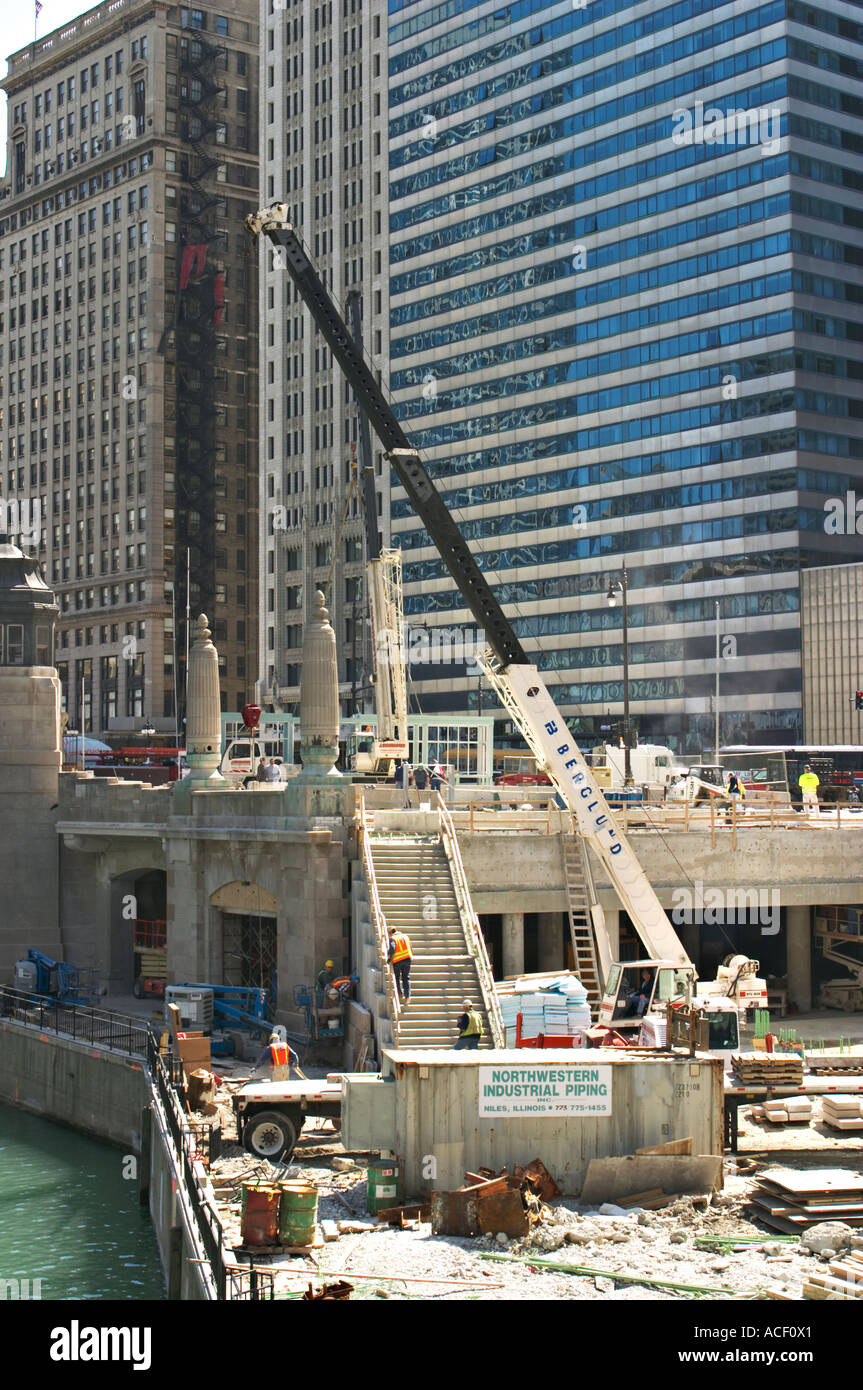 WORKERS Chicago Illinois Construction workers use crane to lift stones ...
