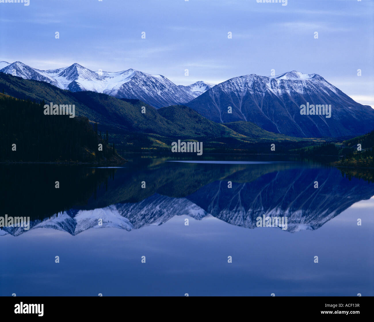 Snow topped mountains reflection in water Stock Photo - Alamy
