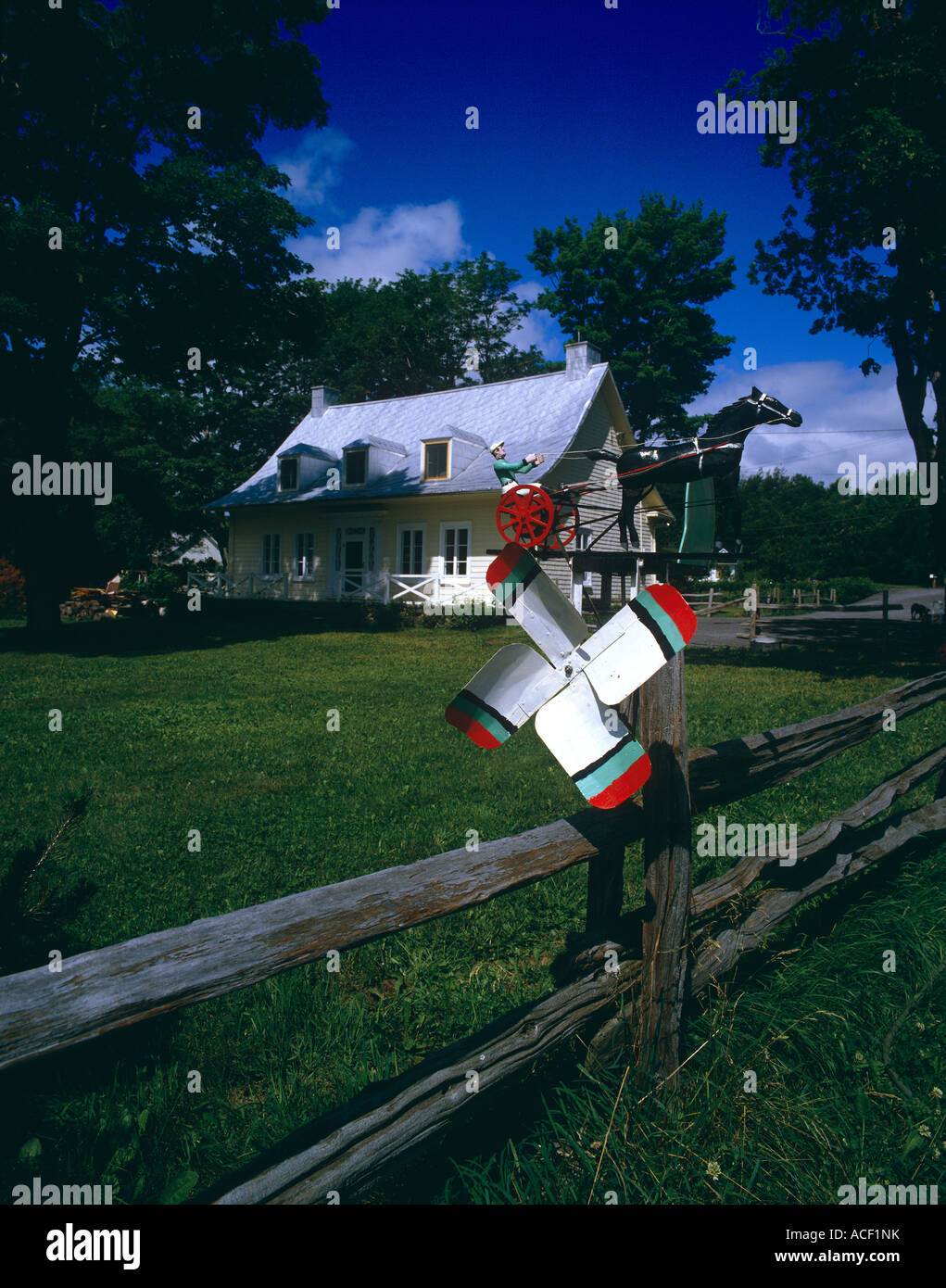 whirl-a-gig mounted on fence post at a quebec farm house in canada ...