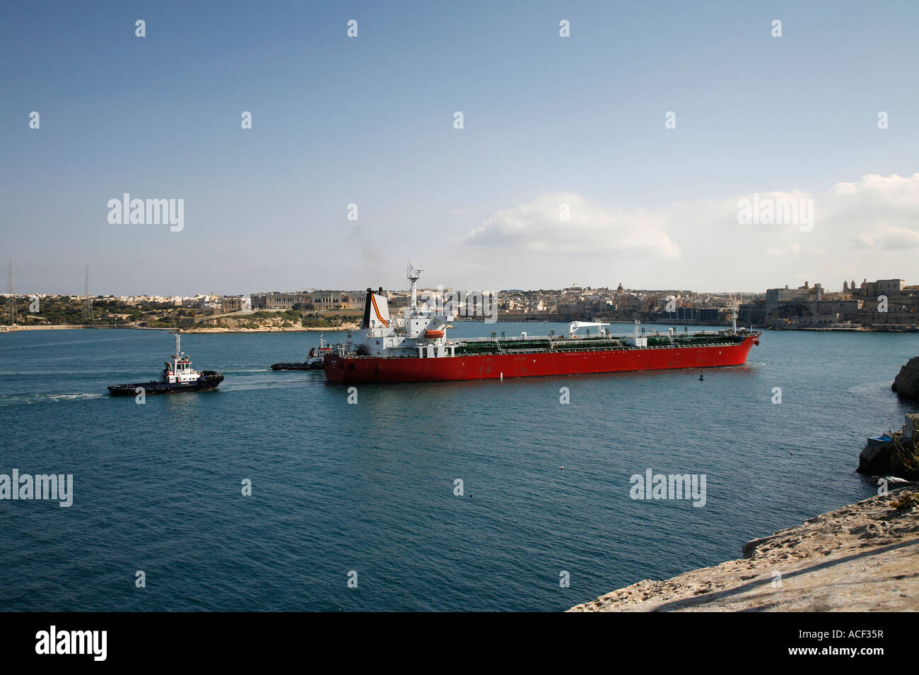 Container Ship entering Grand Harbour, Valletta, Malta, escorted by Tug ...