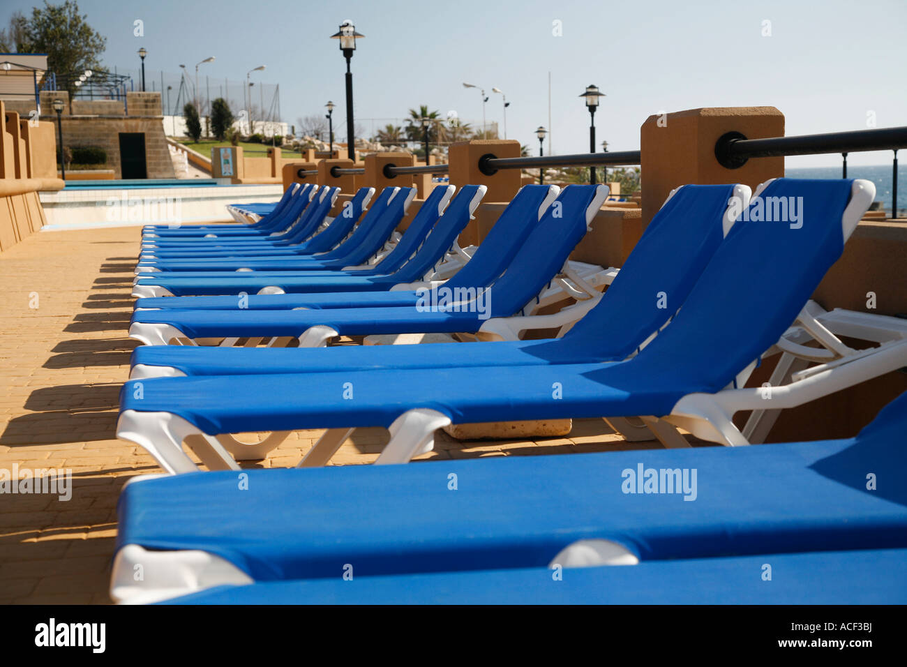 Blue Sunbeds at a 5* hotel Stock Photo - Alamy