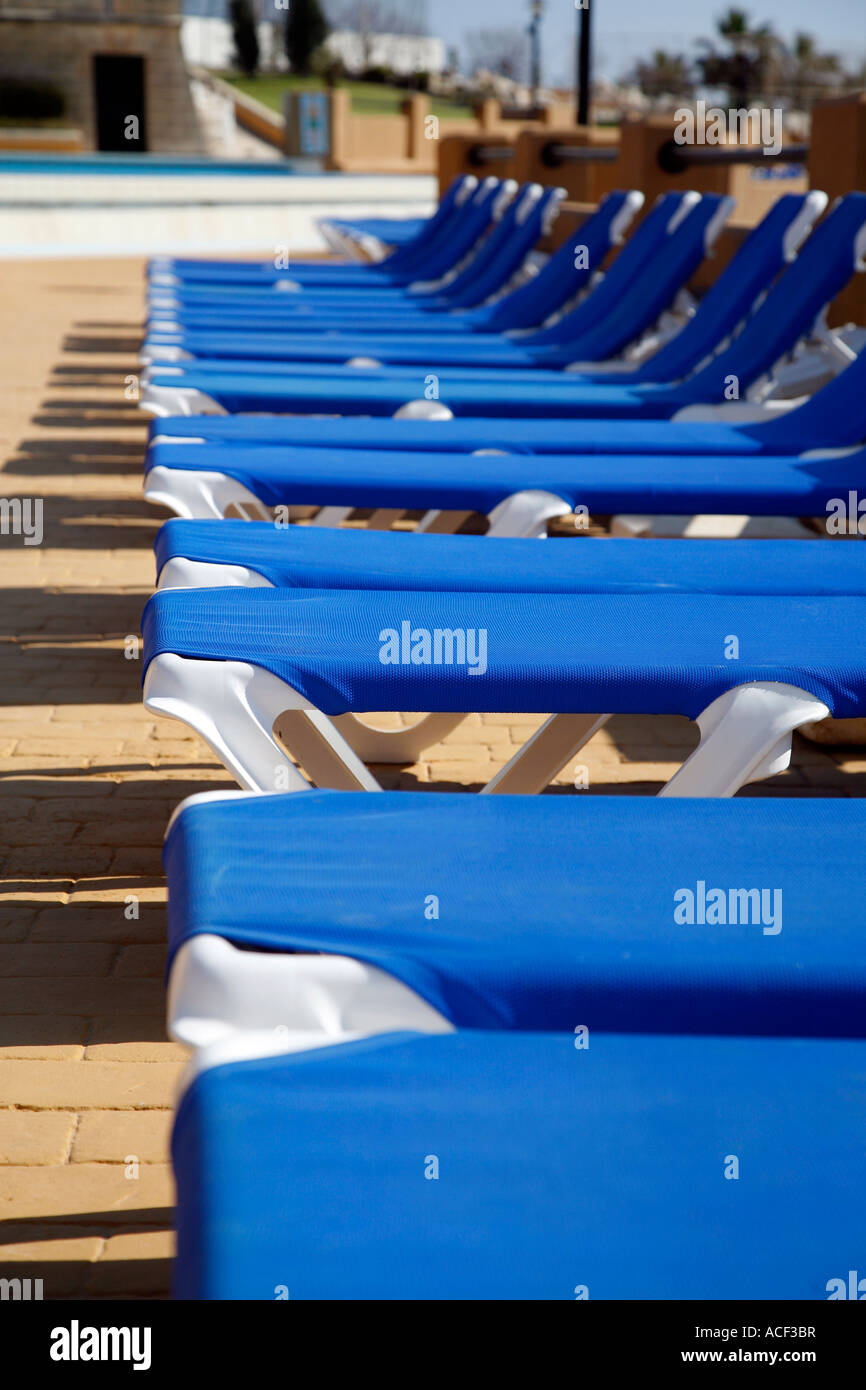Blue Sunbeds at a 5* hotel Stock Photo - Alamy