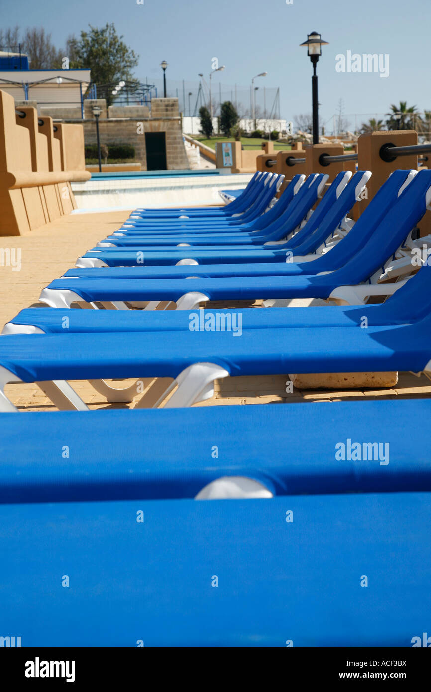 Blue Sunbeds at a 5* hotel Stock Photo - Alamy