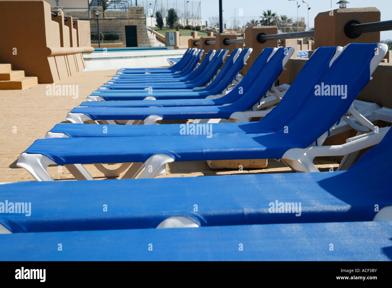 Blue Sunbeds at an hotel Stock Photo - Alamy