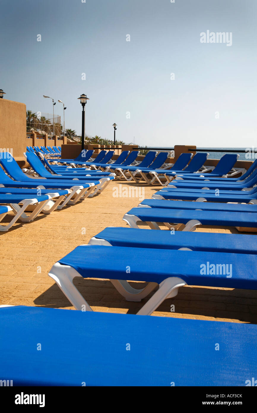 Blue Sunbeds at an hotel Stock Photo - Alamy