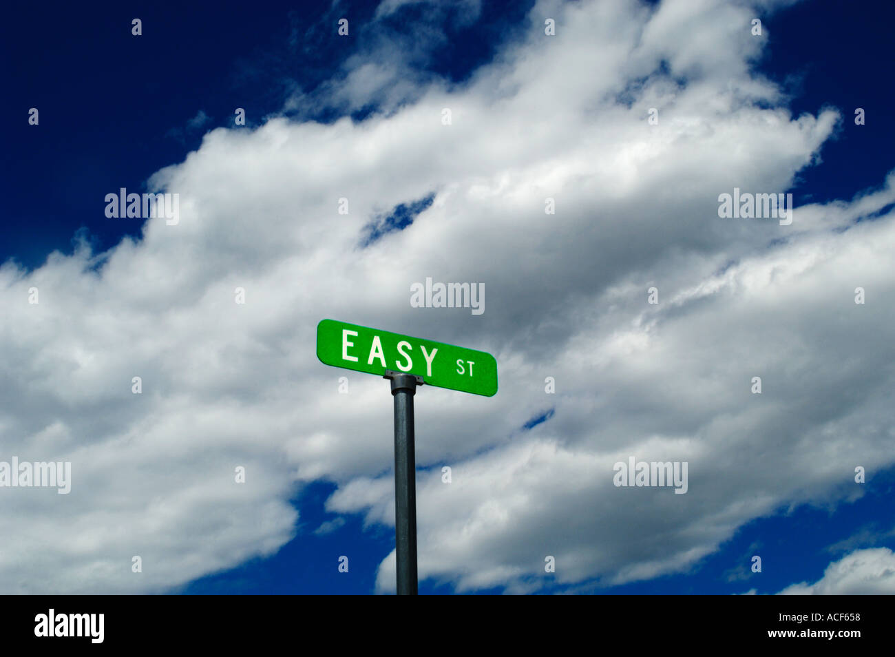Easy street sign with white puffy clouds Stock Photo - Alamy