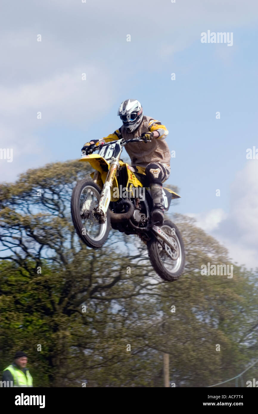 Motocross biker airborne during jump from ramp Stock Photo - Alamy