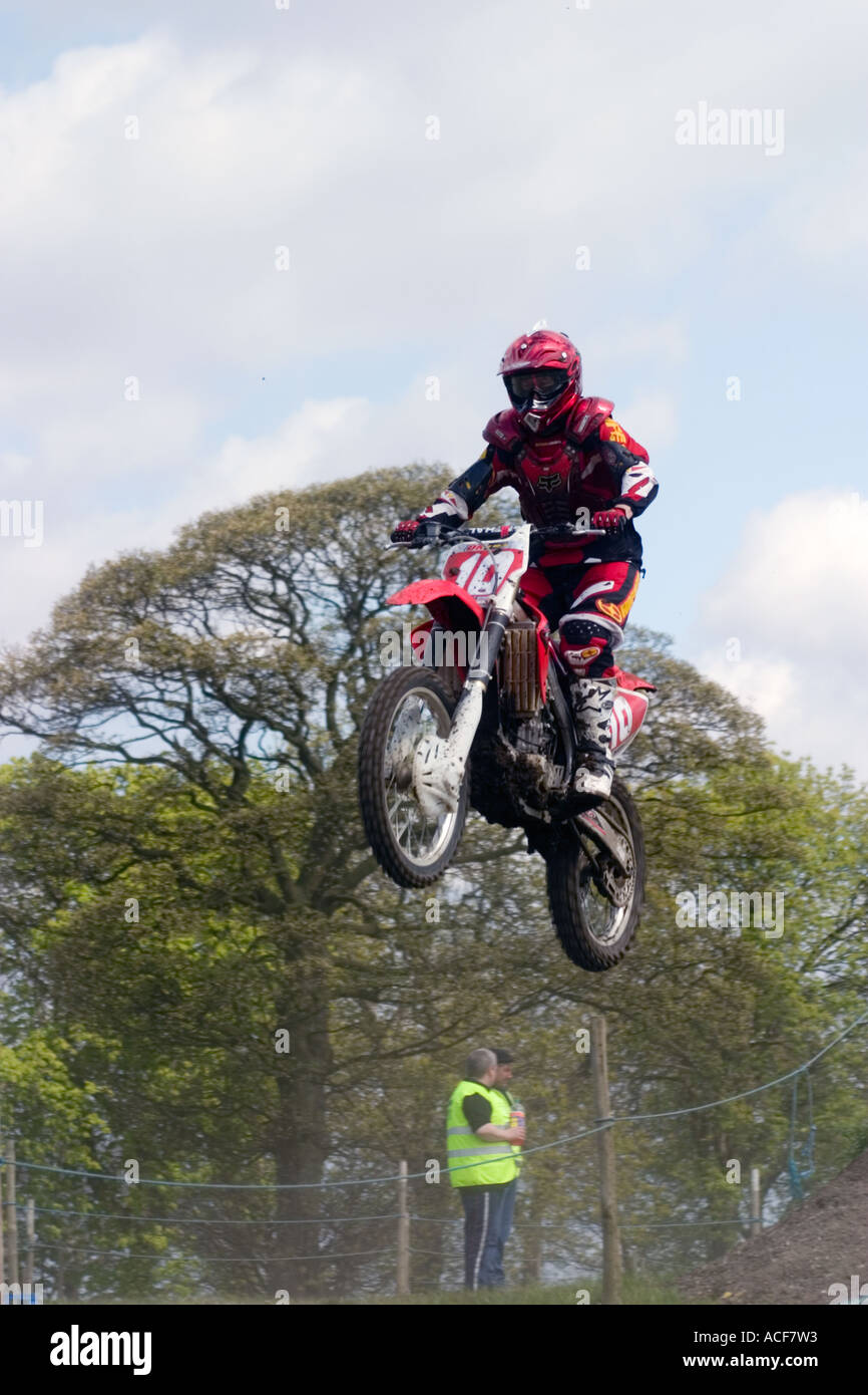 Motocross biker airborne during jump from ramp Stock Photo - Alamy