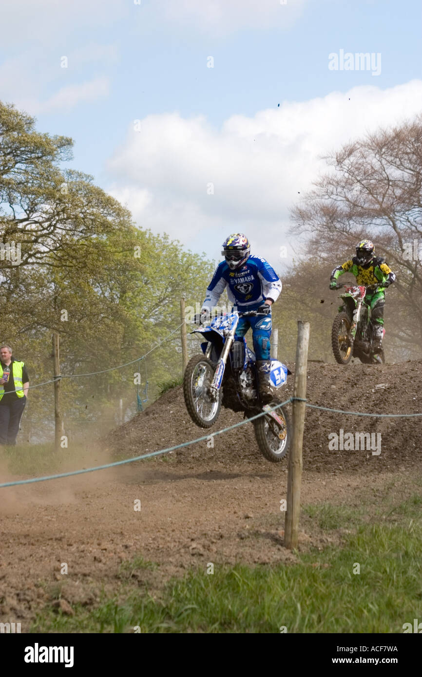 Motocross rider landing after jump Stock Photo - Alamy