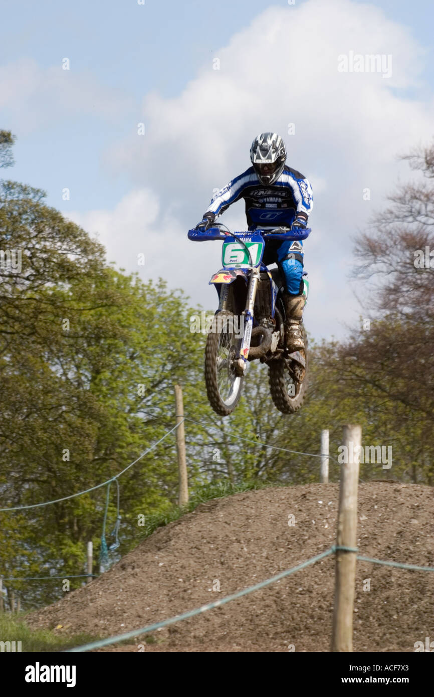 Motocross biker airborne during jump from ramp Stock Photo - Alamy