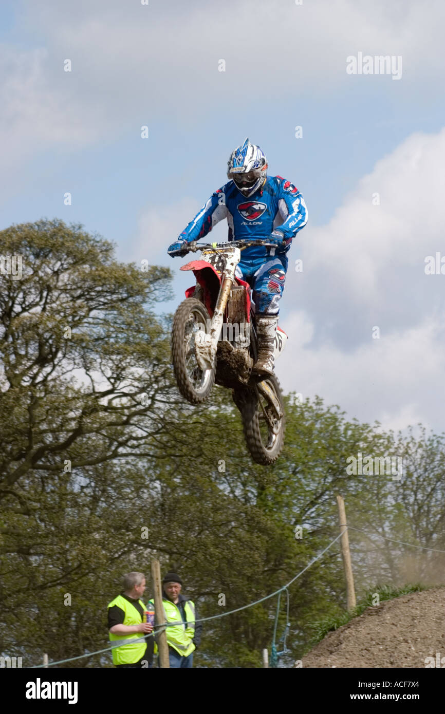Motocross biker airborne during jump from ramp Stock Photo - Alamy