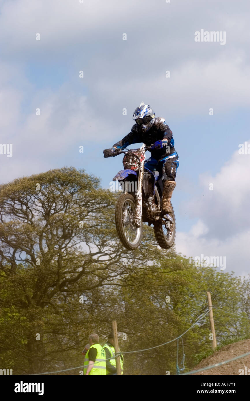 Motocross biker airborne during jump from ramp Stock Photo - Alamy