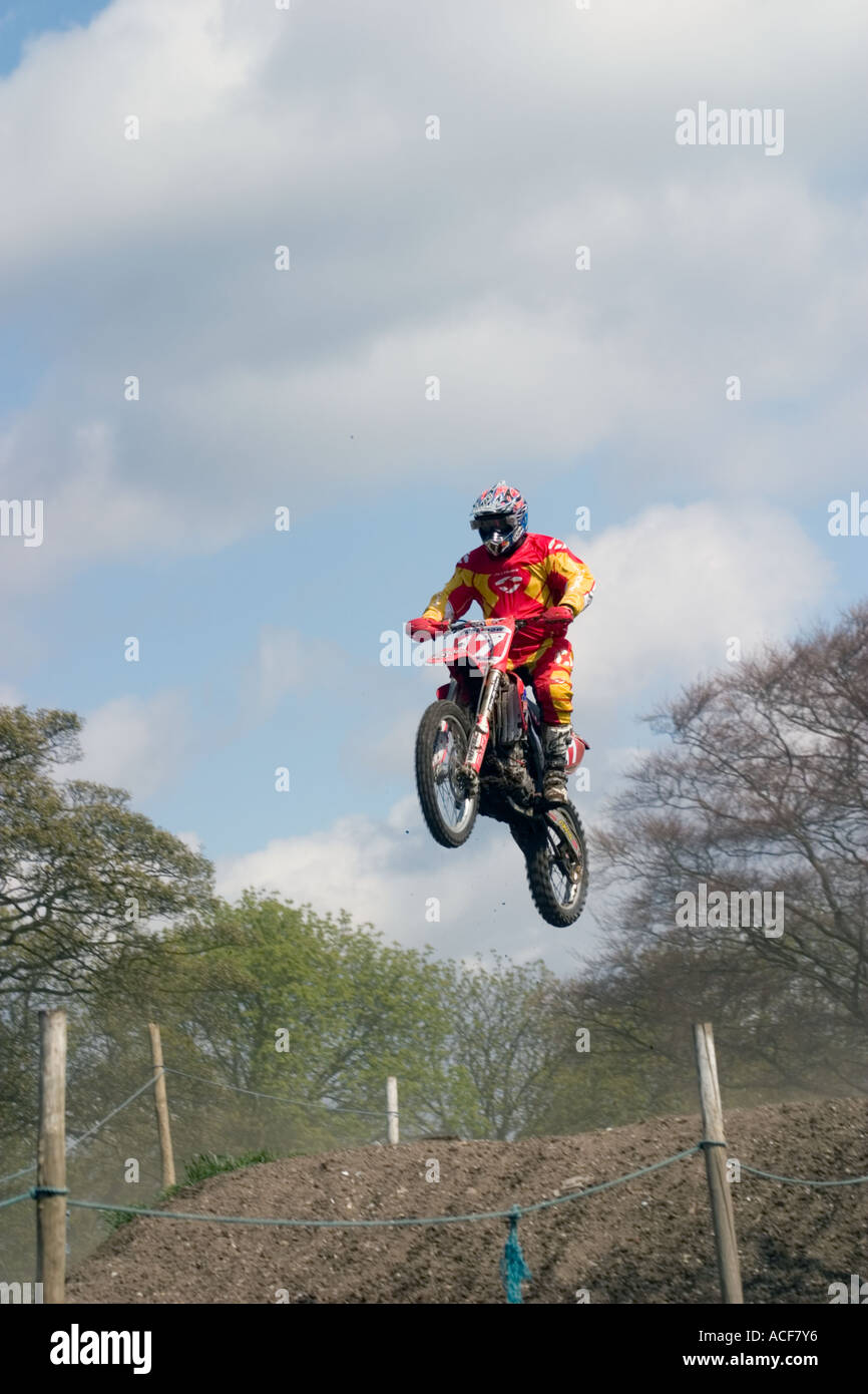 Motocross biker airborne during jump from ramp Stock Photo - Alamy