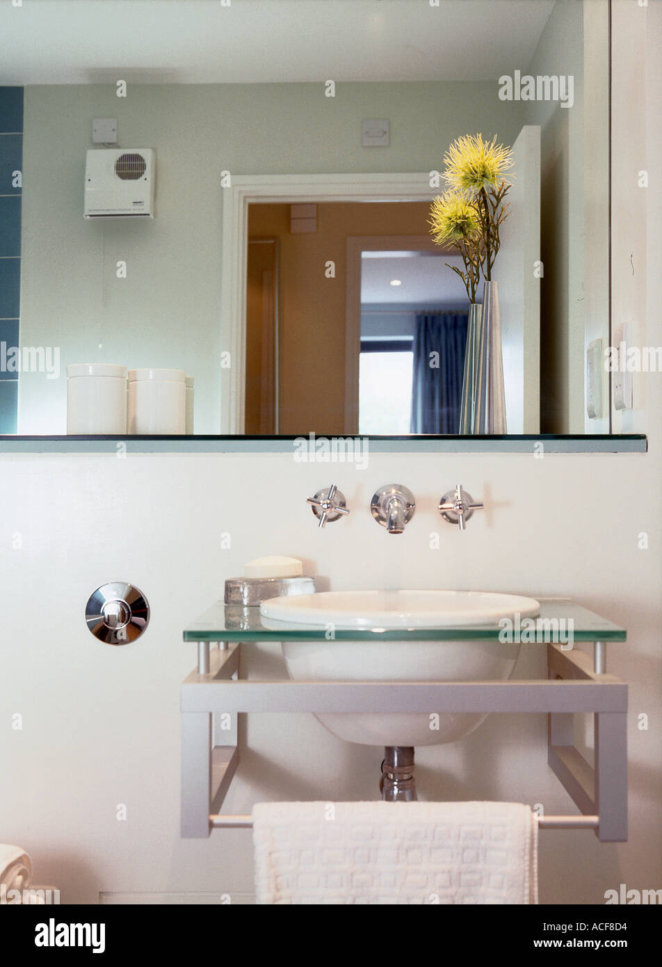 Detail of showcase London luxury flat showing sink and reflection of ...