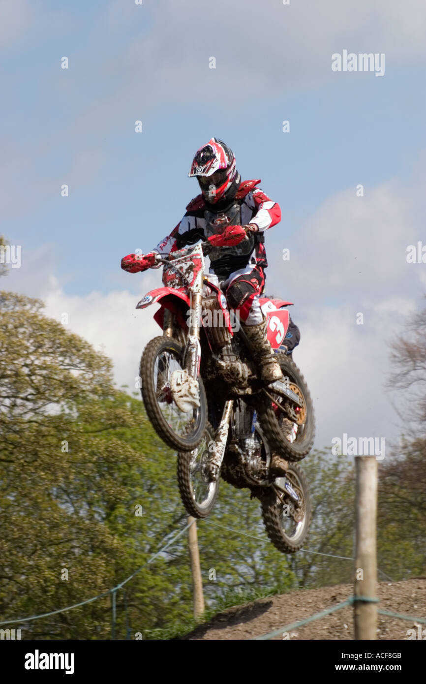 Motocross biker airborne during jump from ramp Stock Photo - Alamy