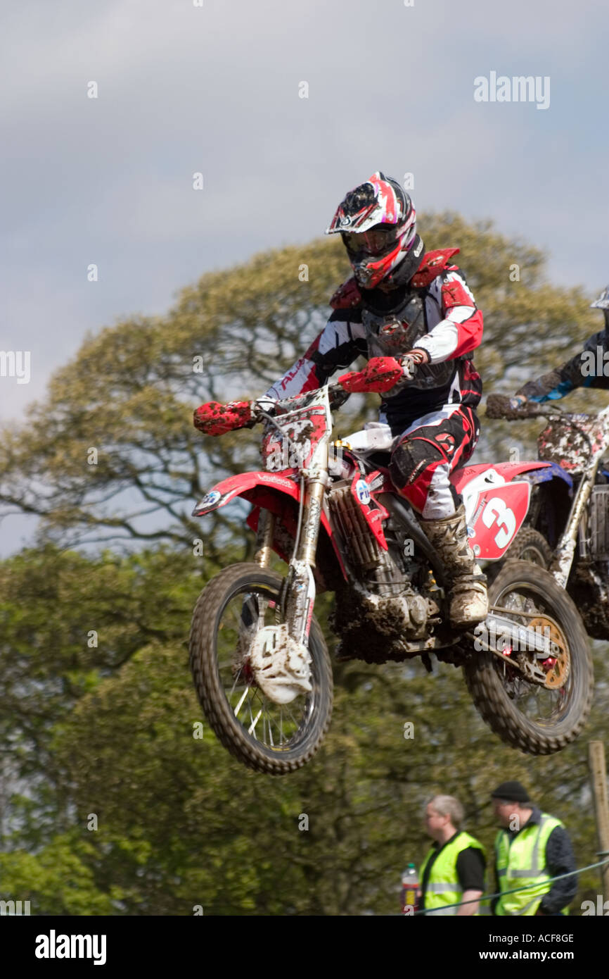 Motocross biker airborne during jump from ramp Stock Photo - Alamy