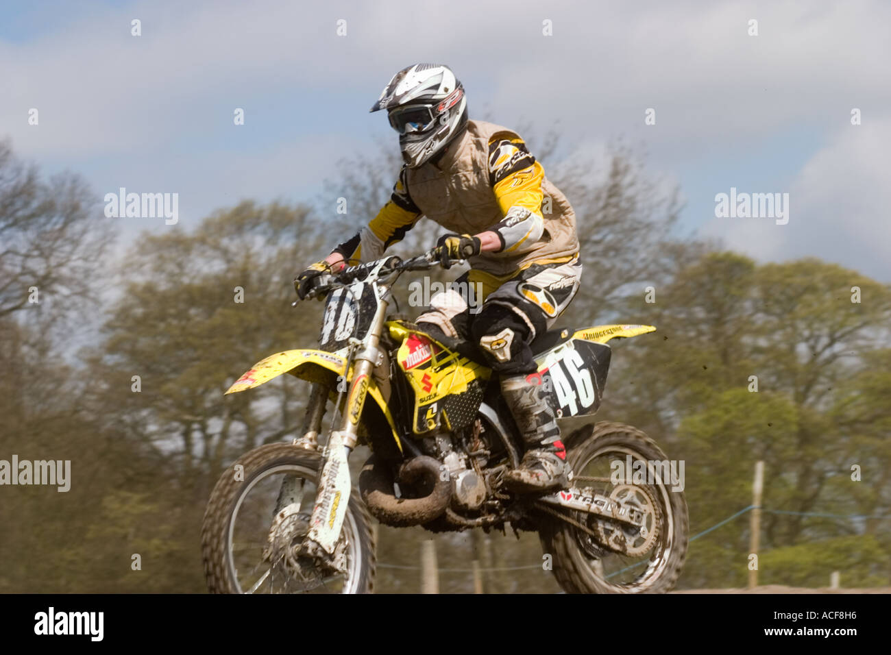 Motocross biker airborne during jump from ramp Stock Photo - Alamy