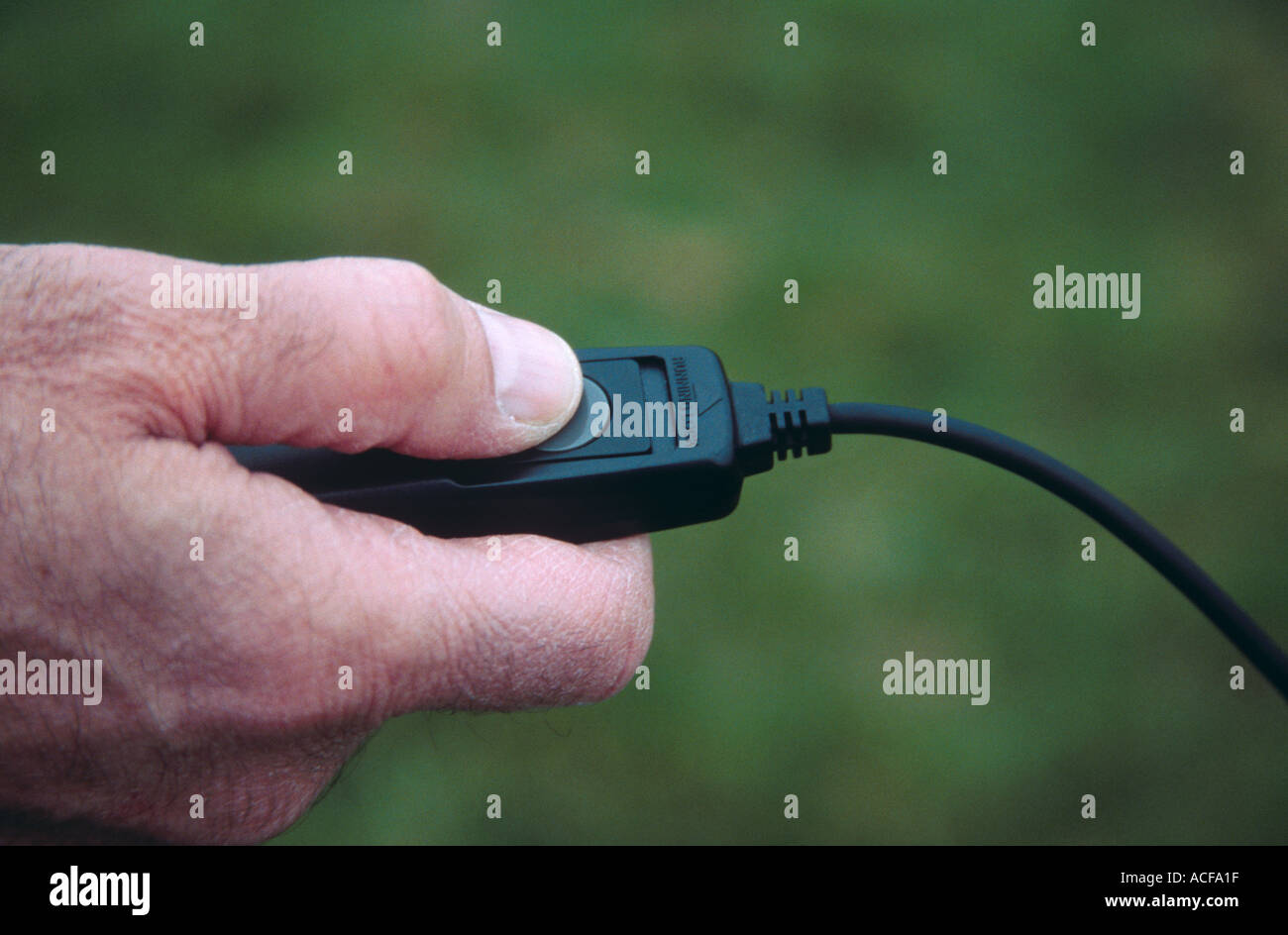 Thumb pressing button of camera remote release Stock Photo - Alamy