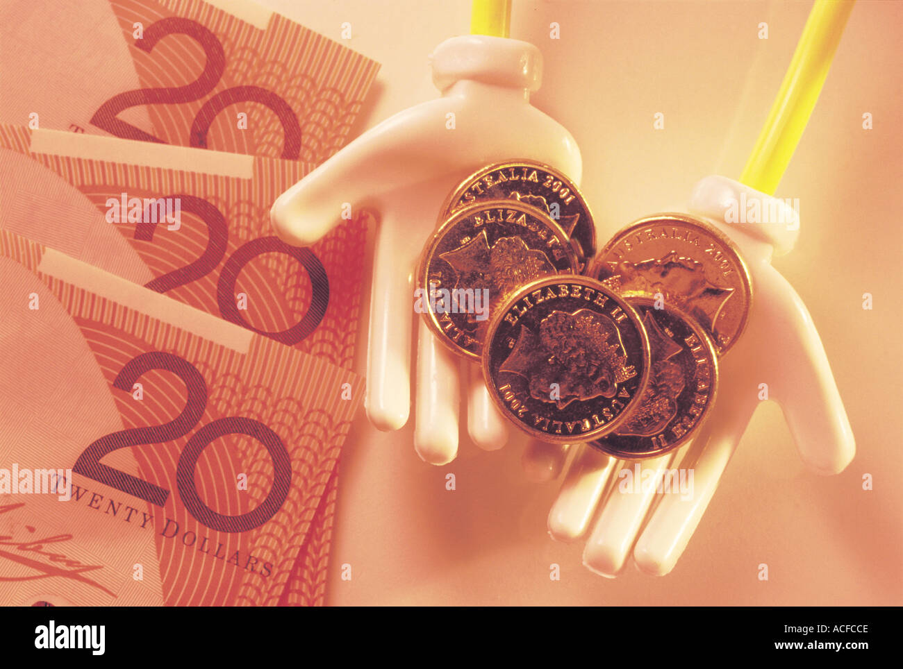 Plastic Toy Hands with Banknotes and Coins Stock Photo - Alamy