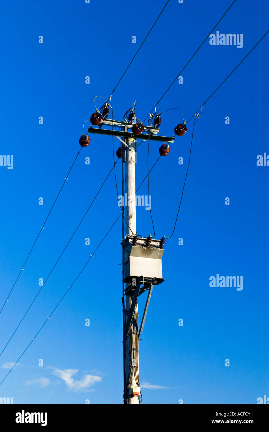 View of a wooden telegraph pole against a blue sky Stock Photo - Alamy