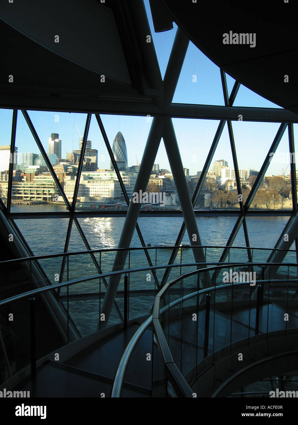 Gherkin and Thames seen through window structure inside City Hall ...