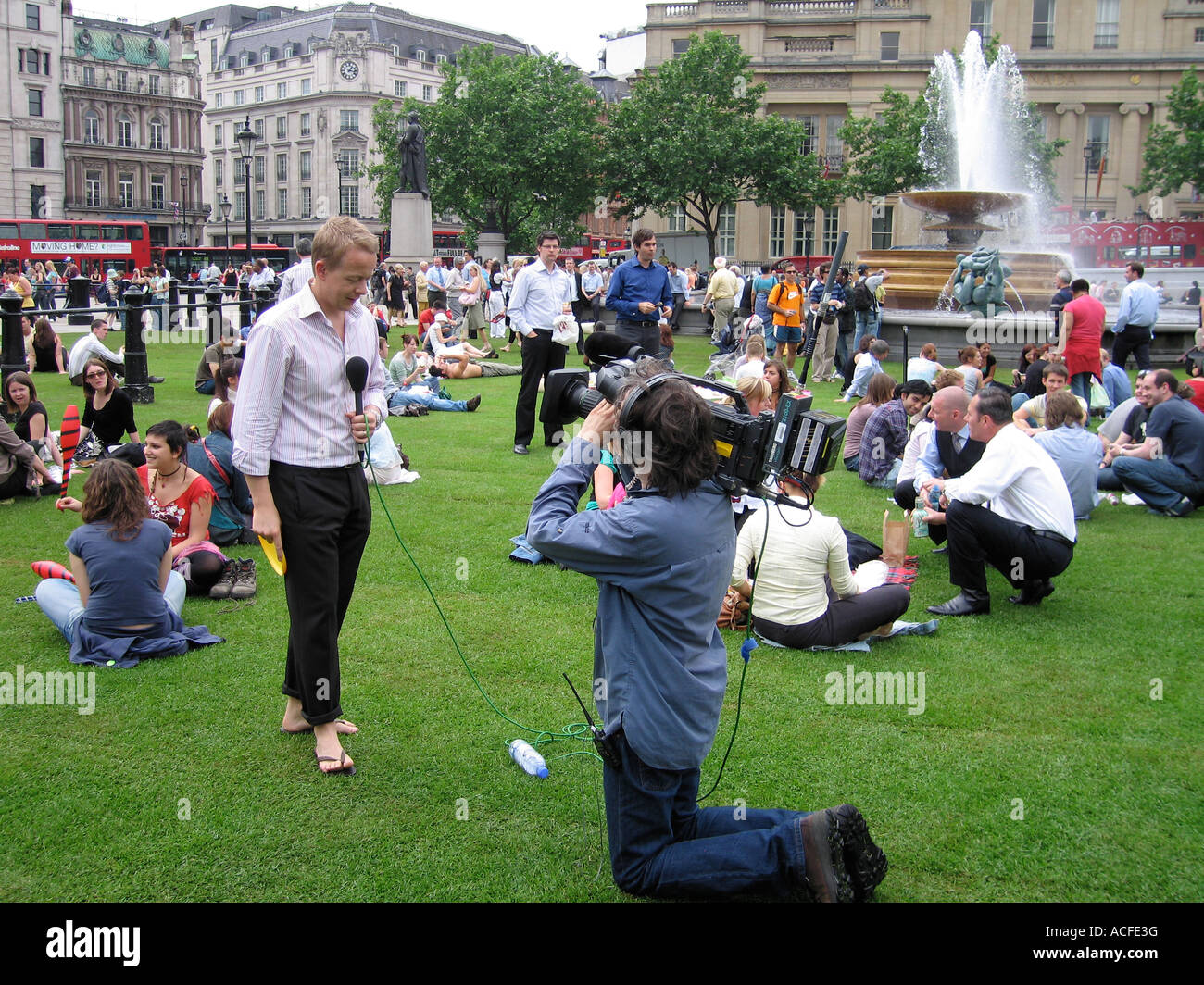 BBC reporter in Trafalgar Square reporting on the green lawn 2007 ...