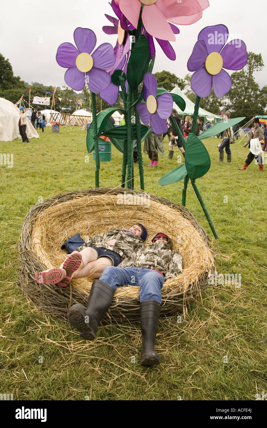 Two girls resining in a giant birds nest in the Healing fields at the ...