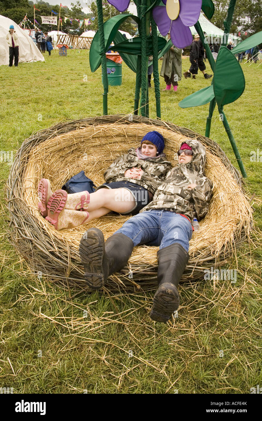 Two girls resining in a giant birds nest in the Healing fields at the ...