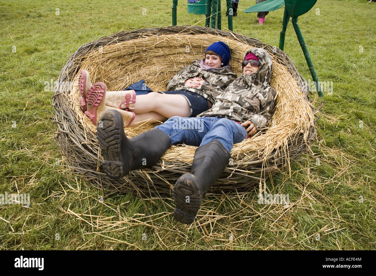 Two girls resining in a giant birds nest in the Healing fields at the ...
