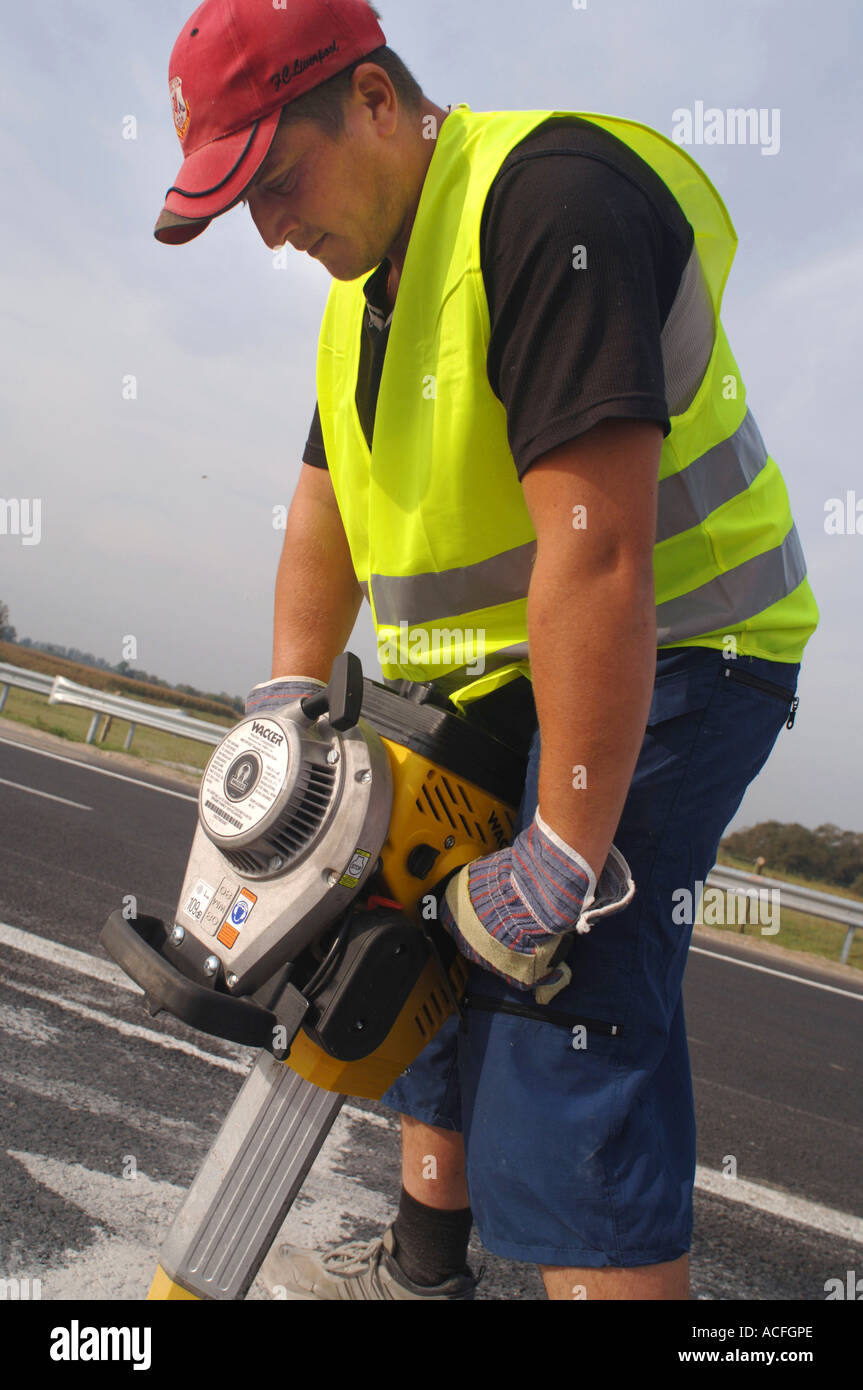 Laying road - workers constructing the M5 toll motorway in Hungary ...