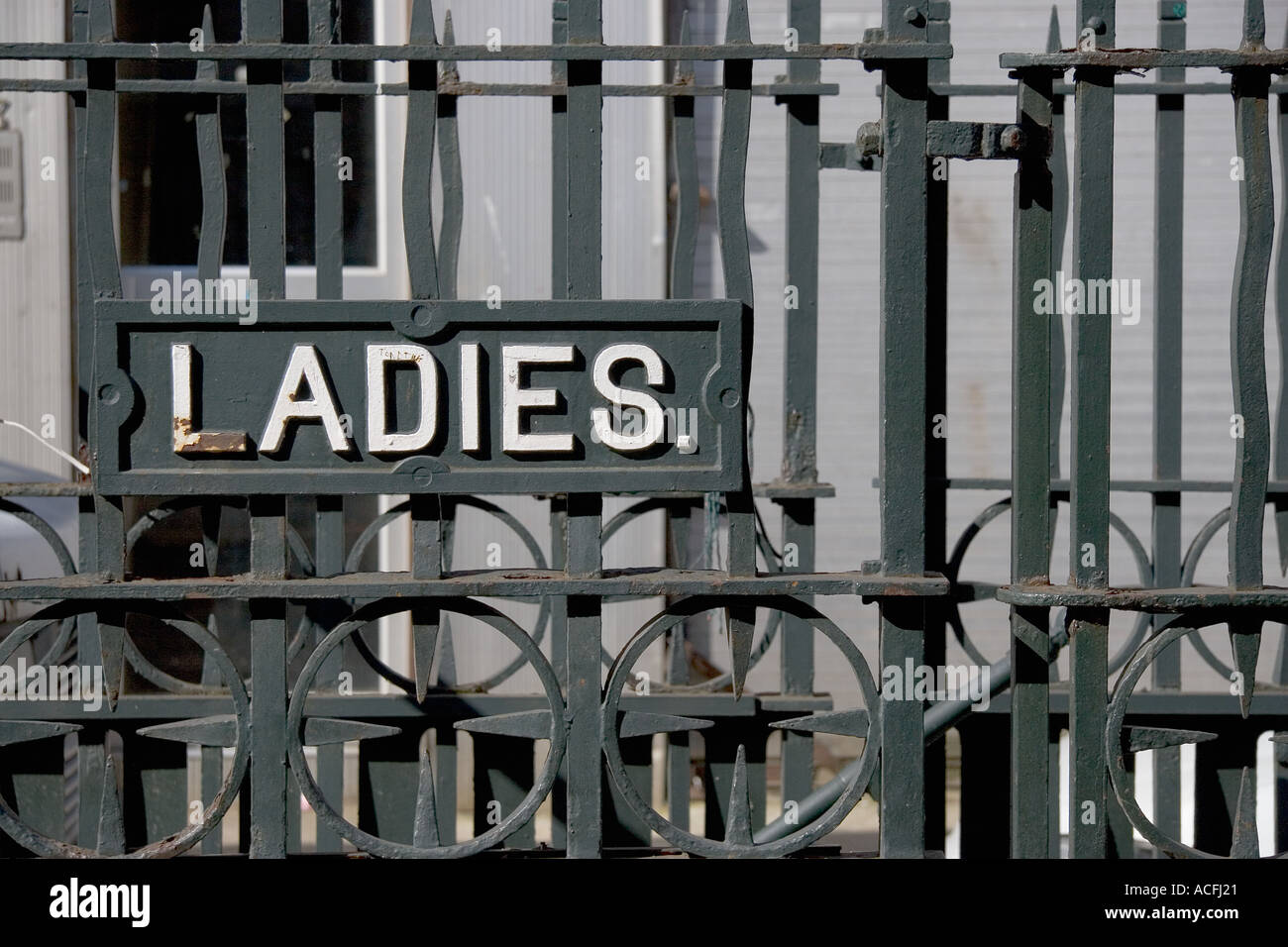 Ladies toilet sign on cast iron gates Stock Photo - Alamy
