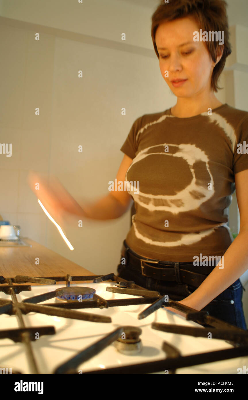 Woman gas flame cooking hi-res stock photography and images - Alamy