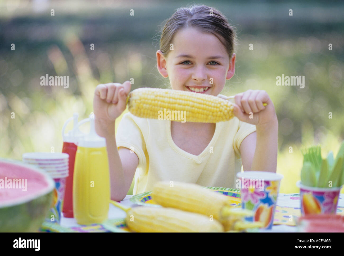 Girl 9 yrs old at picnic eating corn on the cob, Washington State USA ...