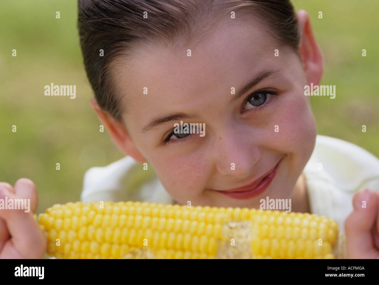 Girl 9 yrs old at picnic eating corn on the cob, Washington State USA ...