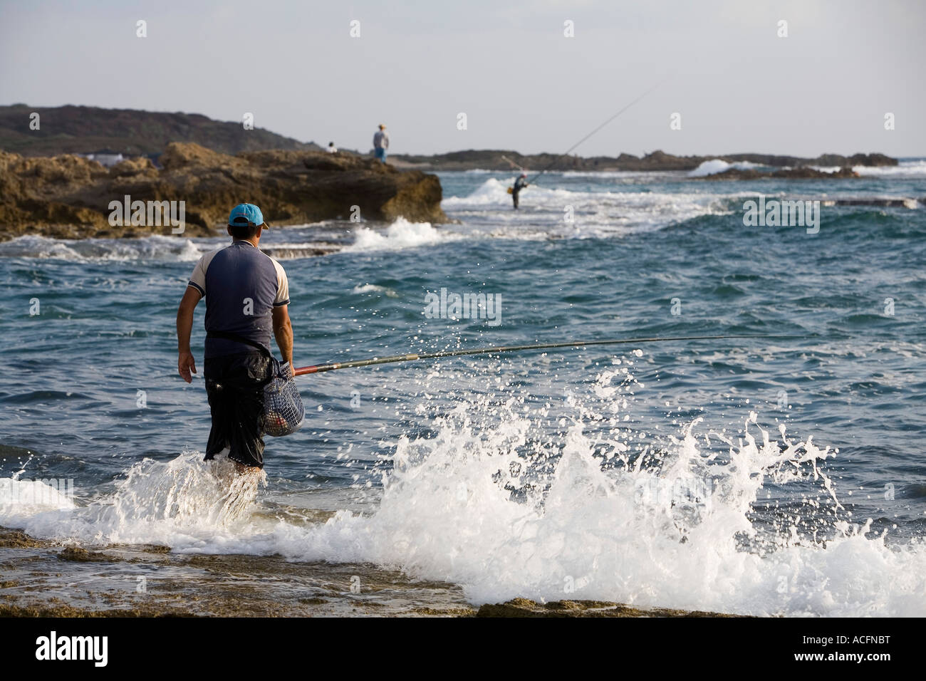 Fisherman in Dor beach, Israel Stock Photo - Alamy