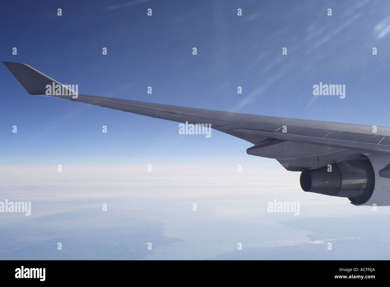 View of the clouds and the aiplane engine on the wing, from airplane ...